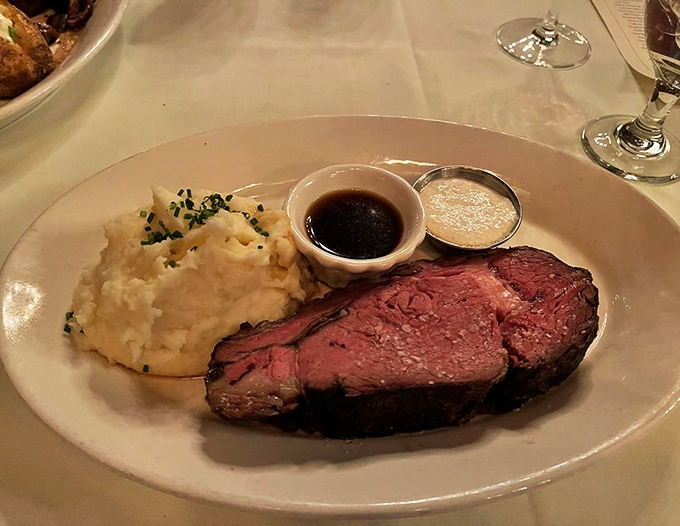 A perfect plate: prime rib, mashed potatoes, and those essential accompaniments. This is what people mean when they say "comfort food elevated."