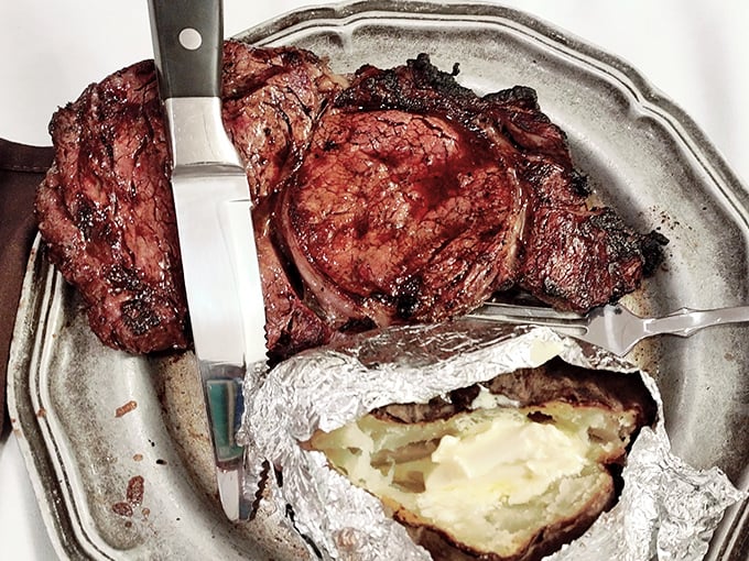 This isn't just dinner&mdash;it's a ceremony of beef. The knife stands ready for its honorable duty of carving through that perfectly cooked prime rib.