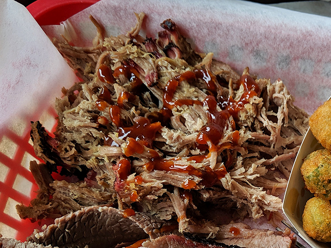 Pulled pork that's had a proper introduction to smoke before meeting sauce. Each tender strand carries flavor messages from barbecue heaven.