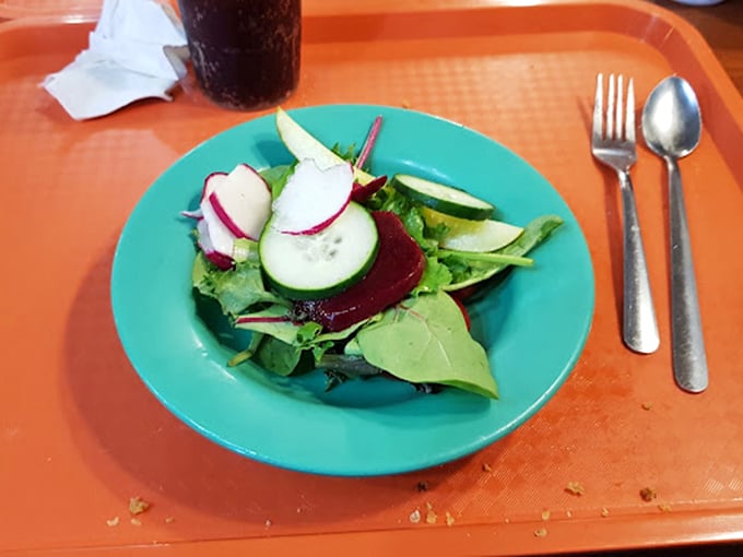 A fresh garden salad makes a noble attempt at balancing your meal, though we both know it's just the opening act.