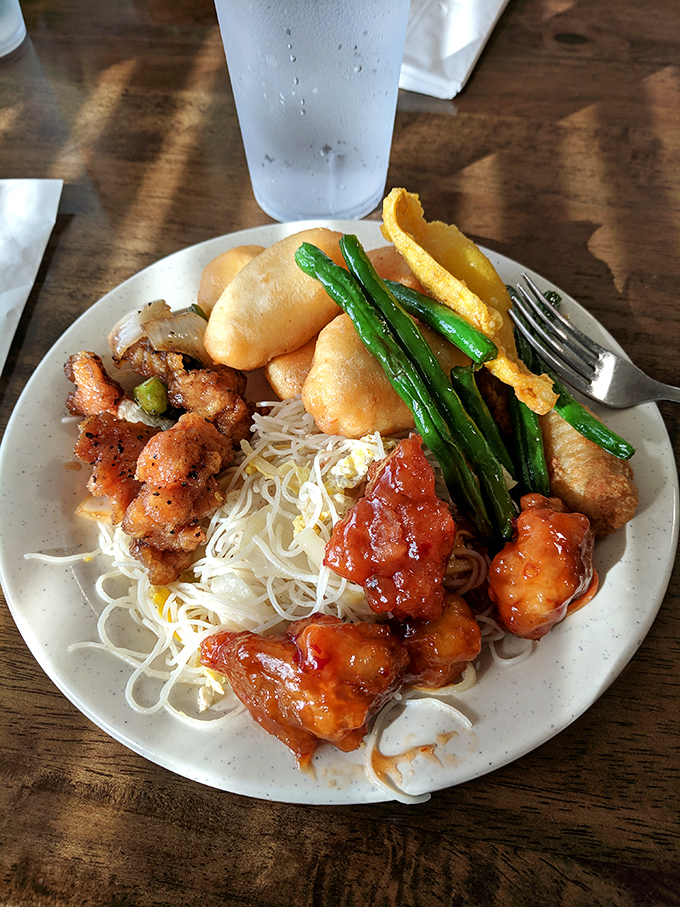 A mountain of noodles, crispy egg rolls, and saucy delights&mdash;the plate that says "I'm definitely getting my money's worth today."