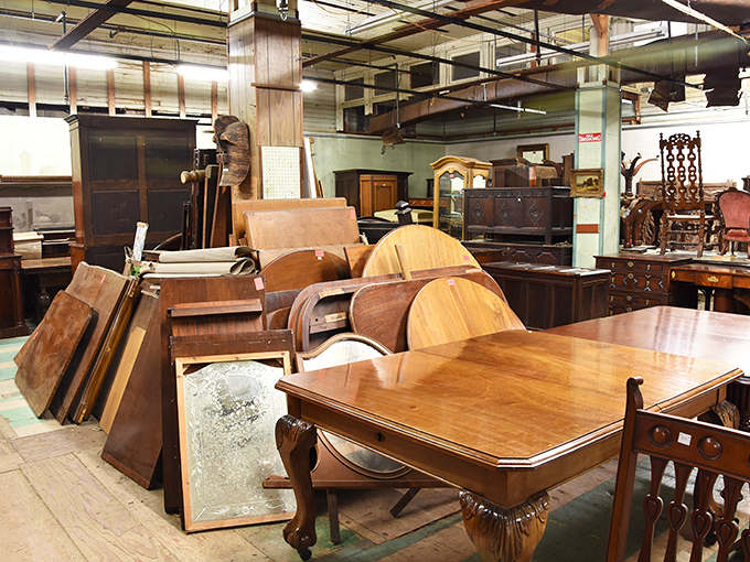 The disassembled dining room squad awaits reassembly. Like puzzle pieces of history, these tables and parts long to host Sunday dinners again.