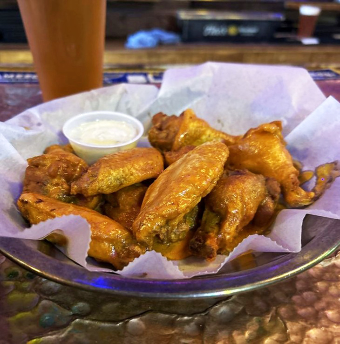 These aren't just wings; they're golden tickets to flavor country, crispier than your uncle's jokes and saucier than gossip at a family reunion.
