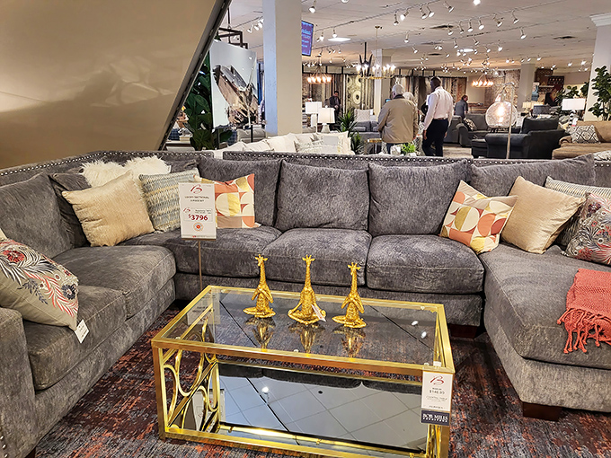 Gray sectional with gold accents: where "I'm just browsing" turns into "I need this in my life immediately." Those giraffe figurines seal the deal.