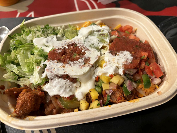 This bowl brings the fiesta – layers of vibrant ingredients topped with a dollop of sour cream, like the culinary equivalent of a well-orchestrated mariachi finale.