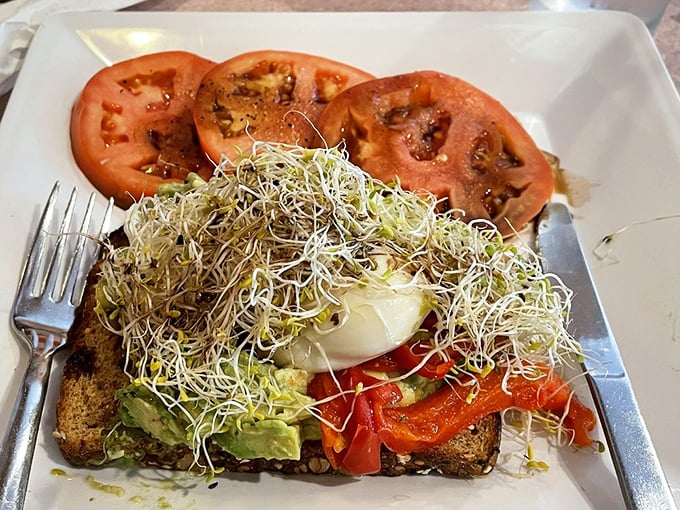 Avocado toast for the health-conscious that doesn't sacrifice flavor - those sprouts create the illusion that you're making responsible breakfast choices.