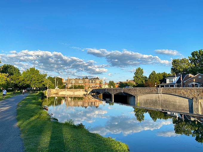 Baker Park's serene waterway reflects clouds that seem painted by a Dutch master. This urban oasis proves that sometimes the best vacation views are in your own backyard.