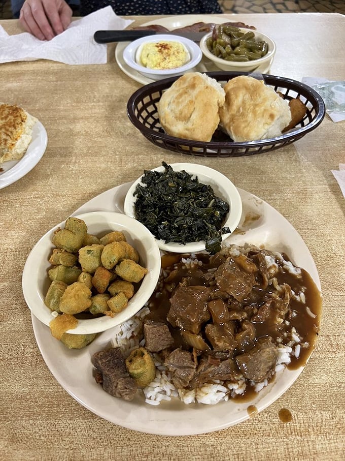 This isn't just lunch—it's a Southern sermon delivered through beef tips, rice, okra, and collards that'll convert any non-believer.