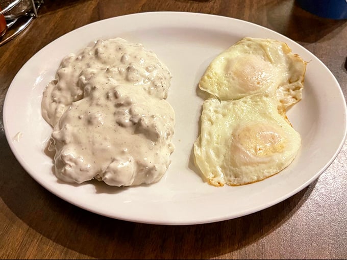 Biscuits and gravy alongside sunny-side-up eggs&mdash;a plate that says "You won't be hungry again until dinner." Challenge accepted.