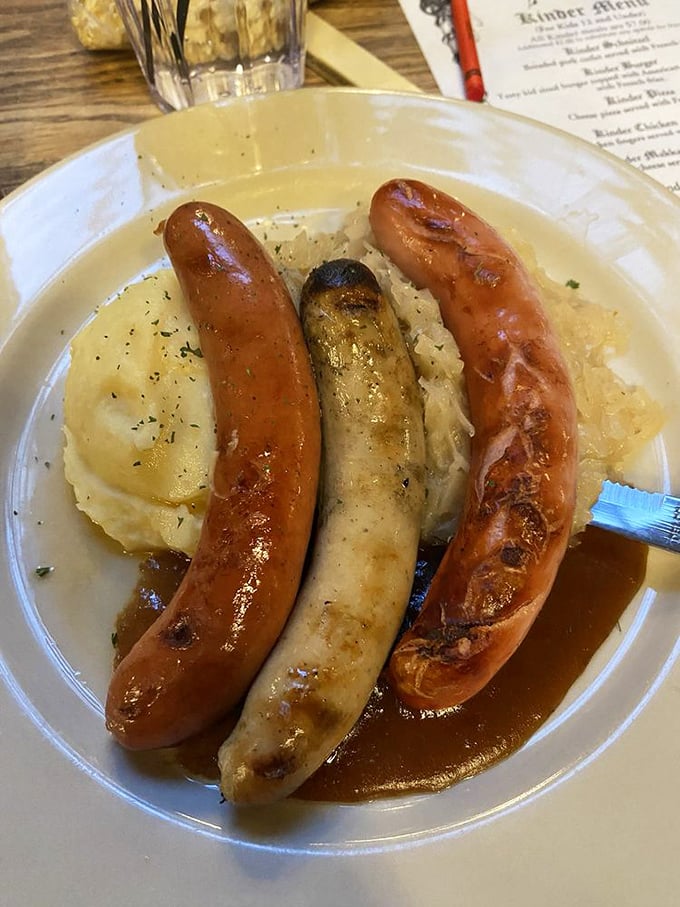 Three sausages standing at attention on a bed of mashed potatoes&mdash;a meaty tribute to German engineering and flavor architecture.