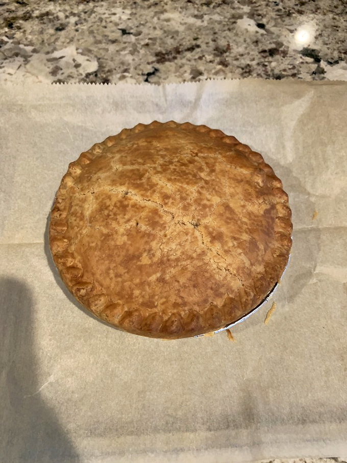 A perfectly golden crust that whispers, "I was made with care." The crimped edges tell stories of generations of pie-making wisdom.