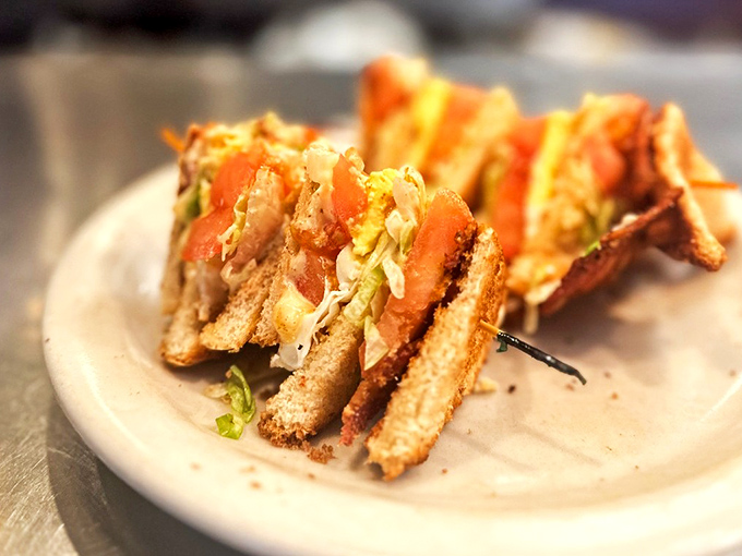 A club sandwich built like a skyscraper of satisfaction &ndash; where each layer contributes to the perfect bite architecture.