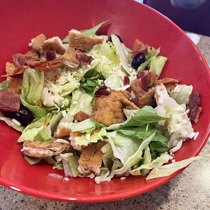 Even their salads come with a side of indulgence. Crisp lettuce playing host to a party of bacon, chicken, and croutons&mdash;health food with personality. 