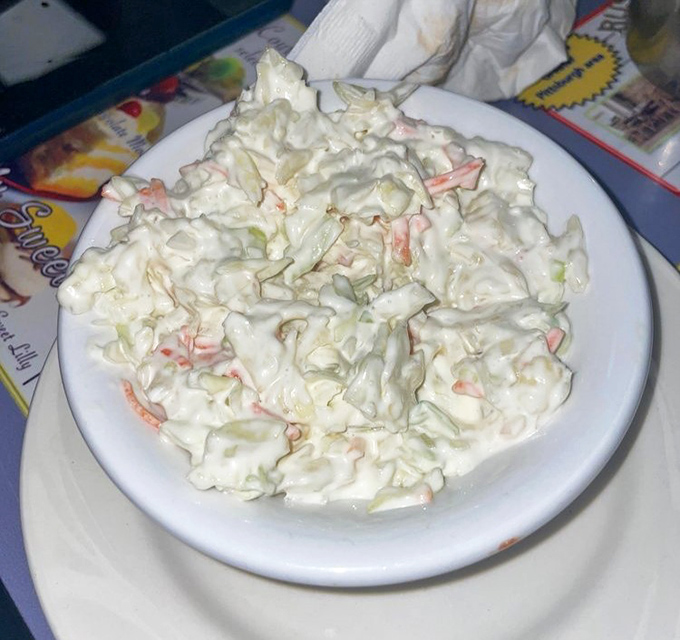 Even the coleslaw gets the royal treatment &ndash; creamy, crunchy, and the perfect cool counterpoint to the diner's heartier offerings.