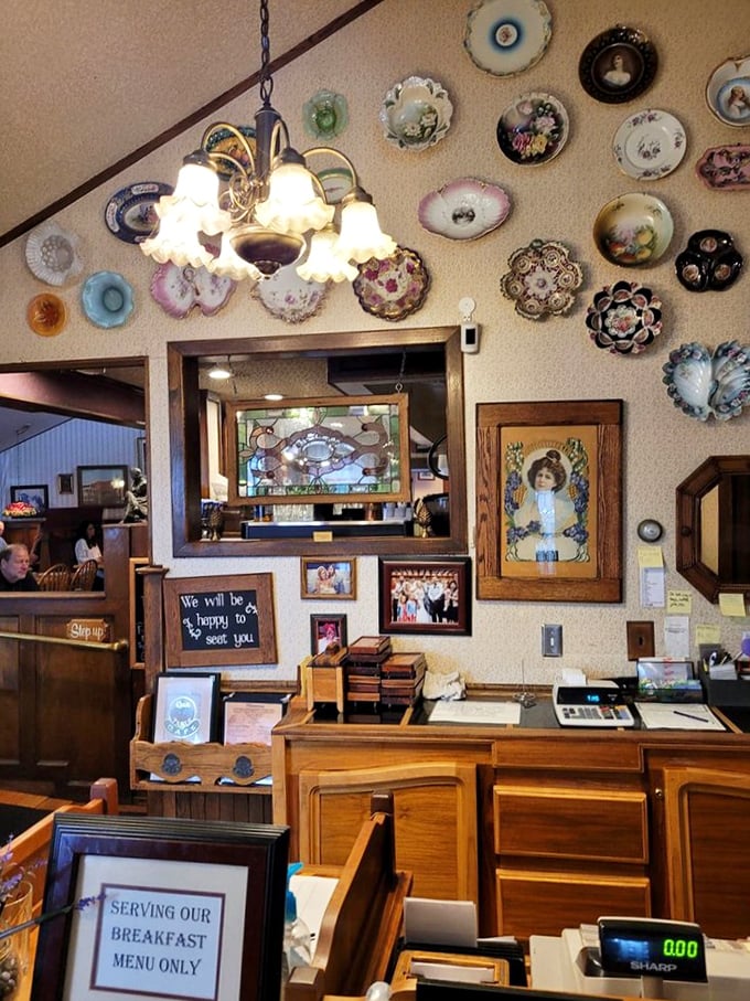 The host station adorned with decorative plates tells you this is a place that cares about details. That "Serving Our Breakfast Menu Only" sign is a badge of specialized honor.