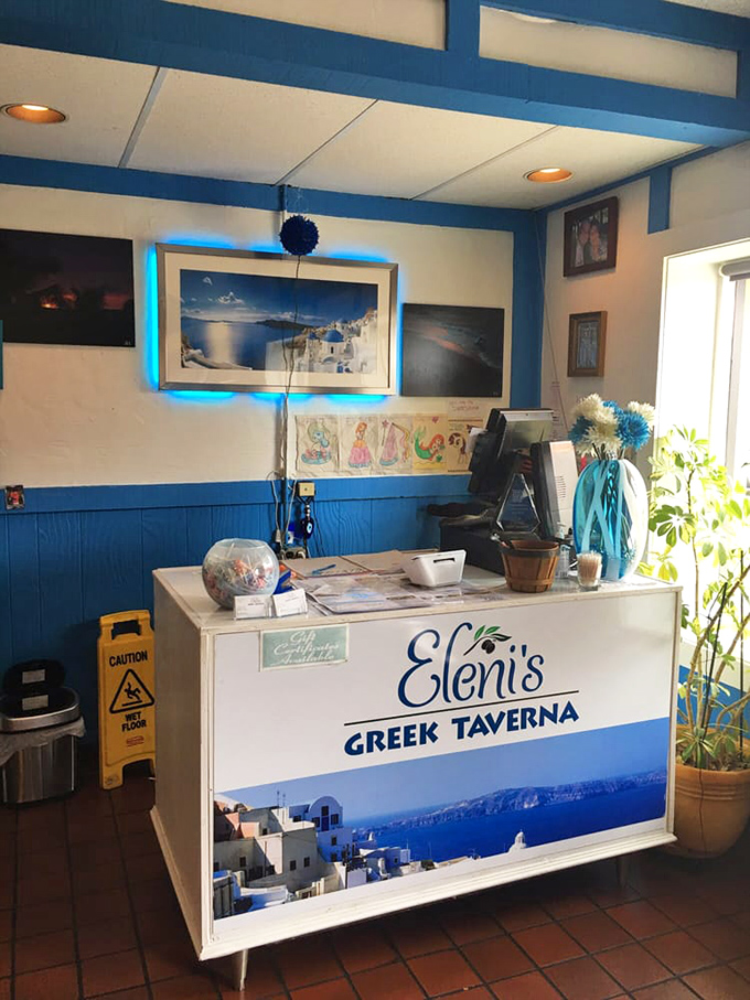 The front counter welcomes you with blue-and-white charm, a preview of the Aegean experience waiting just beyond.