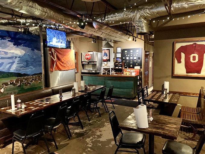 The counter where barbecue dreams come true. That OSU flag and vintage sports memorabilia remind you that team rivalries pause for good food.