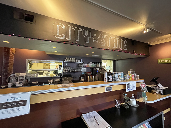 The counter area—where breakfast magic happens behind the scenes. That "CITY STATE" sign glows like a beacon for the hungry and caffeine-deprived. Photo