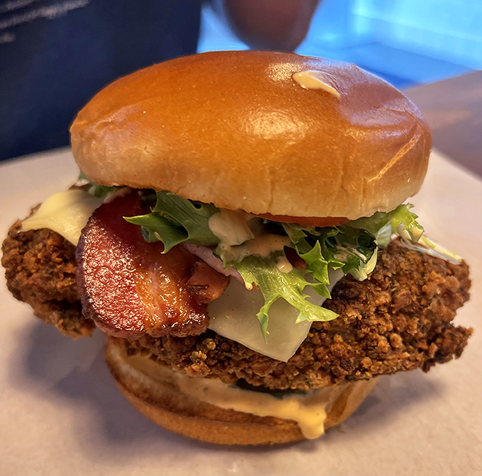 This isn't just a chicken sandwich; it's a masterclass in texture. Crispy coating, tender meat, and fresh toppings in perfect harmony. 