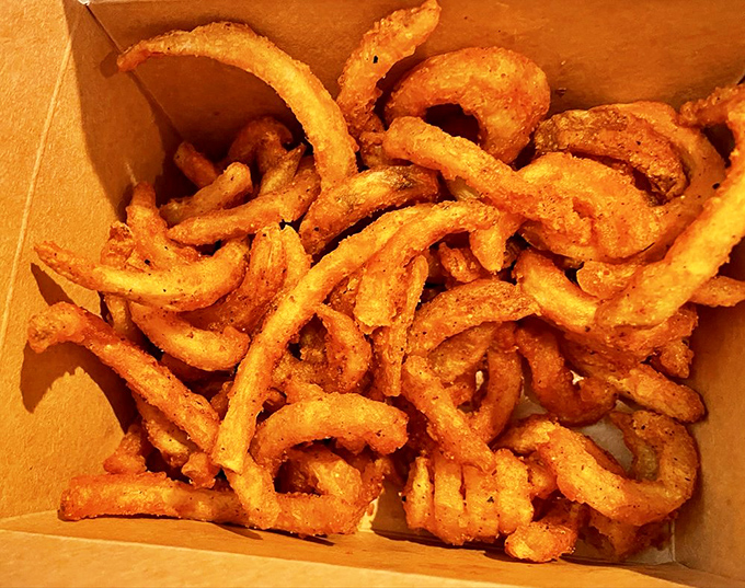 Curly fries dusted with their signature rub&mdash;the perfect vehicle for sopping up any sauce left on your plate.