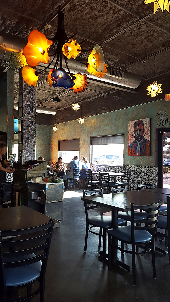 Those flower-shaped light fixtures bloom from the ceiling like exotic desert plants, casting a warm glow that makes everyone look like they're on vacation.