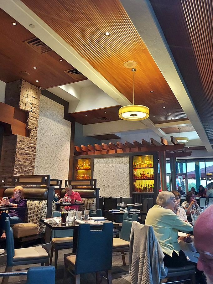 The interior's warm wood ceiling and stone accents create an atmosphere where both date nights and family dinners feel equally at home.