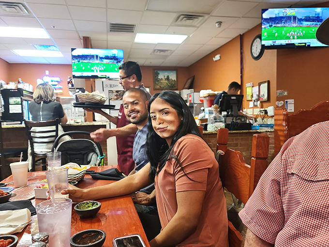 Happy diners experiencing that universal moment of joy when the food exceeds expectations and the company makes it even better.