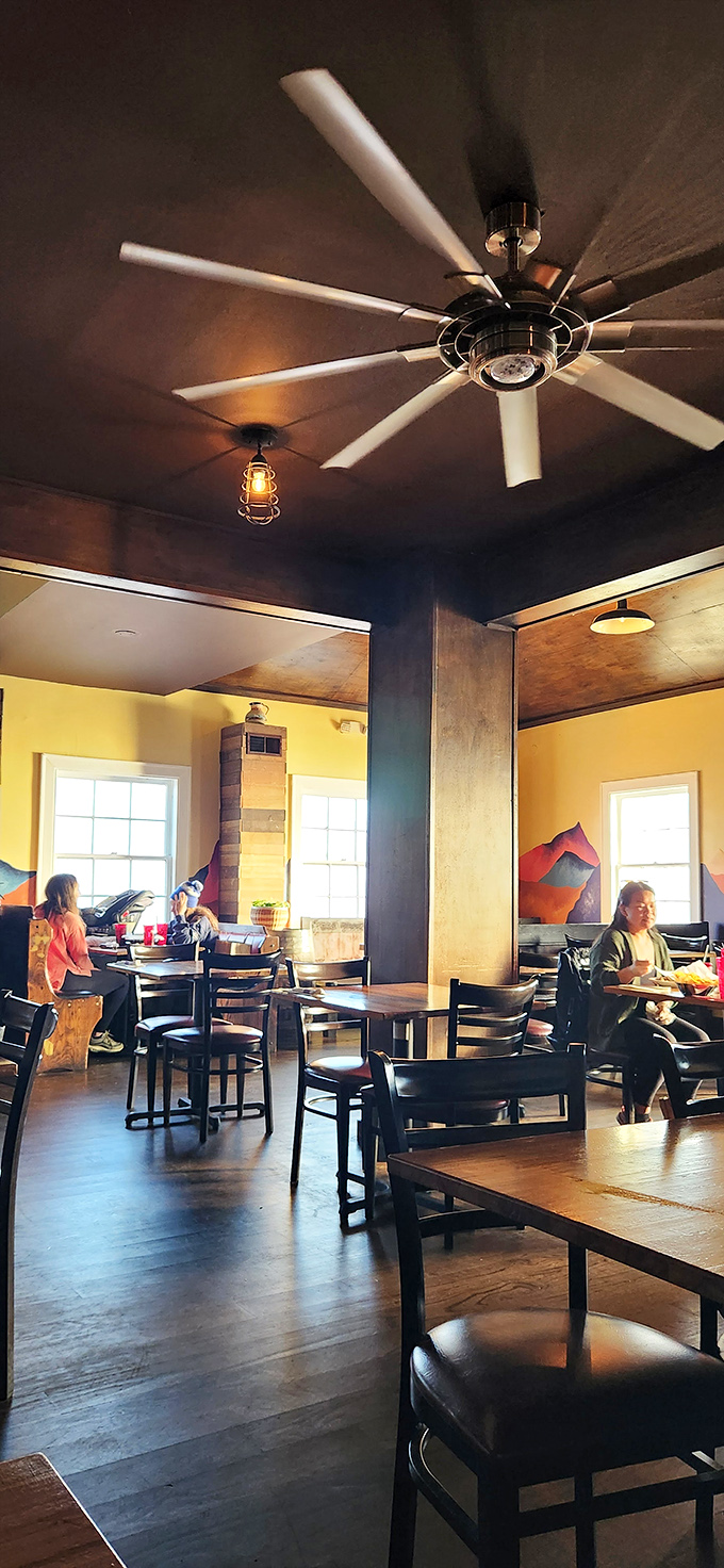 The dining room buzzes with the energy of happy eaters under industrial-chic ceiling fans, all united in the pursuit of chimichanga bliss.