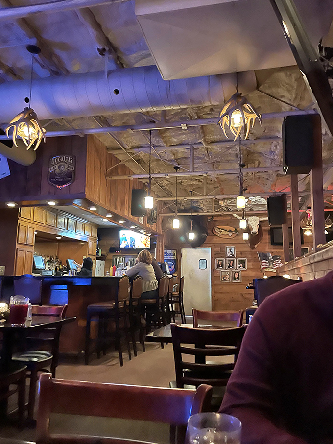 The bar area glows with amber light, promising cold drinks and warm conversation. This is where local legends are born over prime rib.