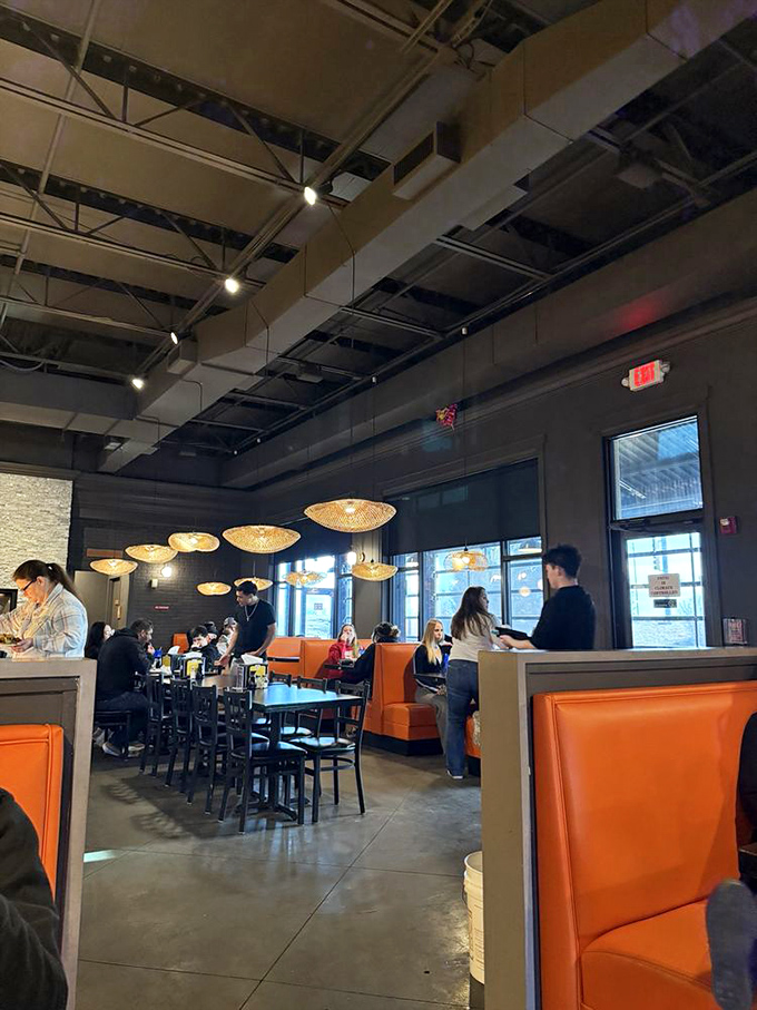 Where food dreams come true&mdash;diners enjoying the fruits of their strategic buffet planning in stylish orange booths.