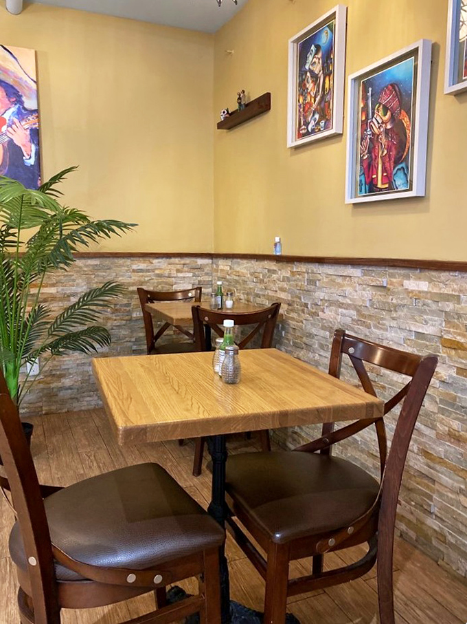 Cozy corner tables invite intimate conversations over meals, while artwork watches over diners like colorful guardians of good taste.