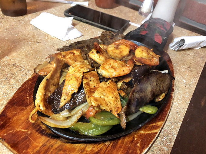 Sizzling fajitas: the dinner and the show. That steam isn't just smoke—it's aromatic theater announcing the arrival of your main event.