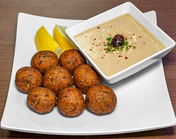 Falafel balls posing proudly next to their hummus companion&mdash;like a family portrait where everyone actually got along that day.