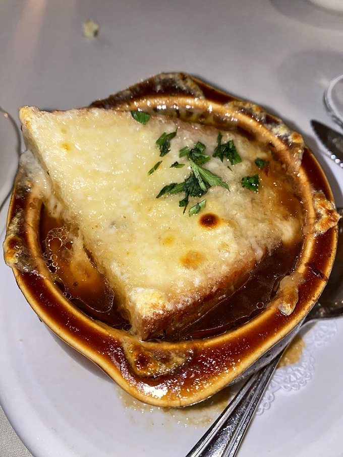French onion soup with a cheese cap so perfect it deserves its own superhero cape. Comfort food that's dressed for a black-tie event.