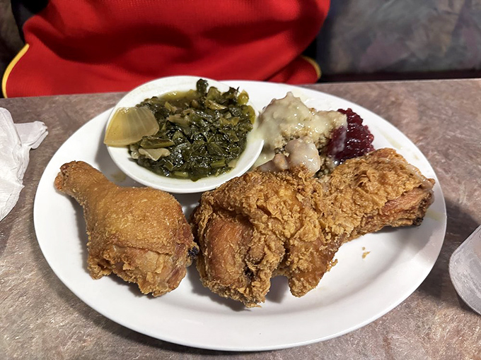 Fried chicken with the golden ratio of crunch to juiciness, served with collard greens. This plate doesn't just feed your body&mdash;it nourishes your soul.