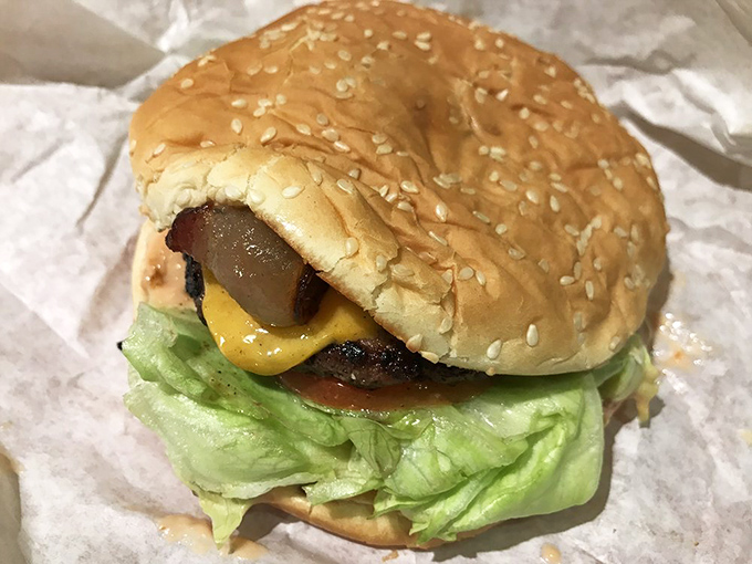 Behold the burger in its natural habitat&mdash;nestled in paper, oozing with promise, and making you wonder why you ever waste time eating anything else. 