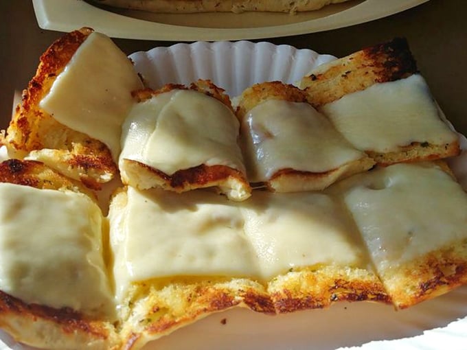 Garlic cheese bread that performs the impossible task of upstaging the pasta&mdash;golden, buttery slices topped with melted cheese that stretch dramatically with each bite.