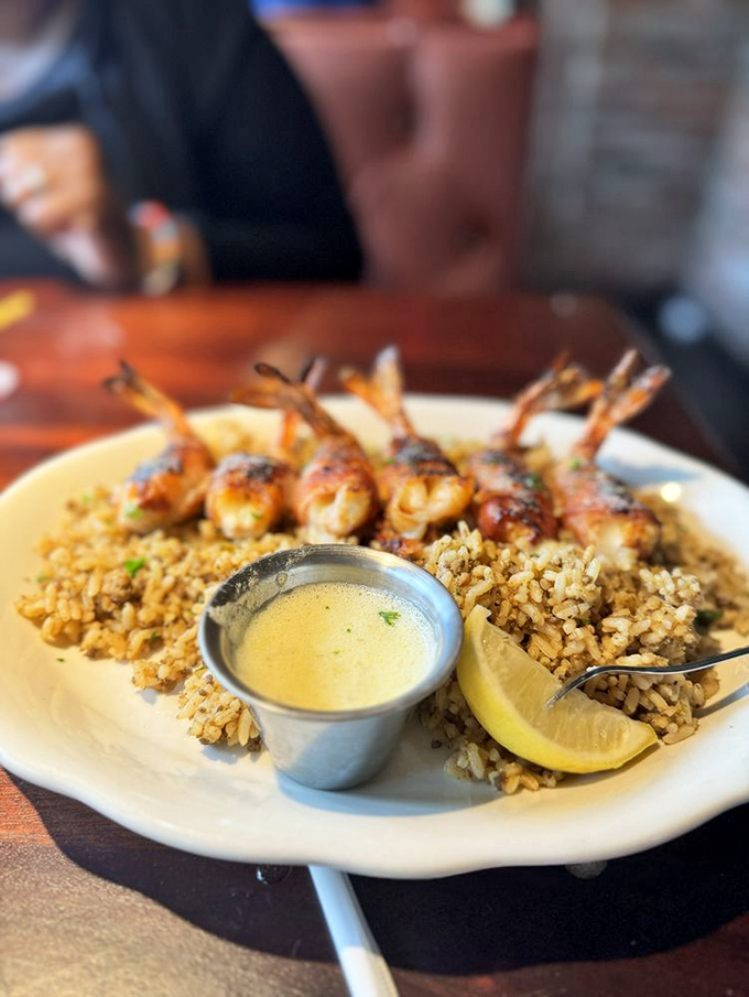 Grilled shrimp perched atop dirty rice like jewels on a crown. The accompanying lemon butter sauce begs to be sopped up with bread.