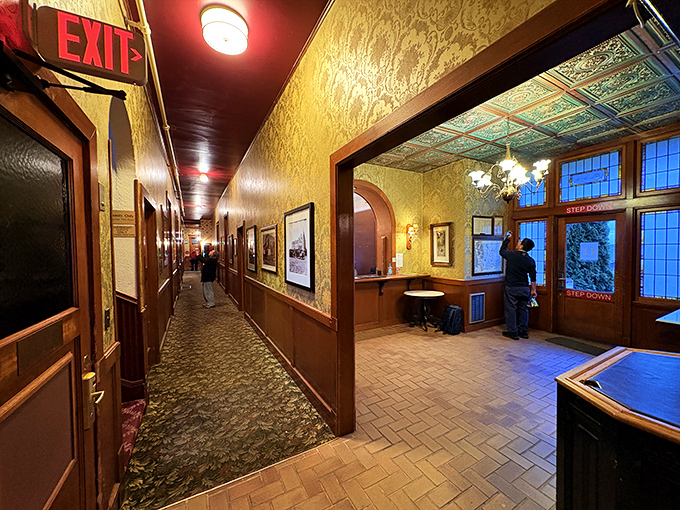 The entrance hallway welcomes guests with golden wallpaper and historical photos, setting the stage for your temporary life as castle nobility.