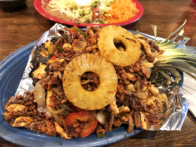 A tropical vacation on a plate&mdash;grilled pineapple rings crown this mountain of seasoned protein and vegetables. The pineapple hollow centers frame the dish like edible picture frames.