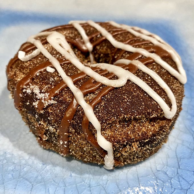 A donut topped with whipped cream and a straw&mdash;because sometimes drinking your dessert takes too long. This is efficiency at its most delicious. 