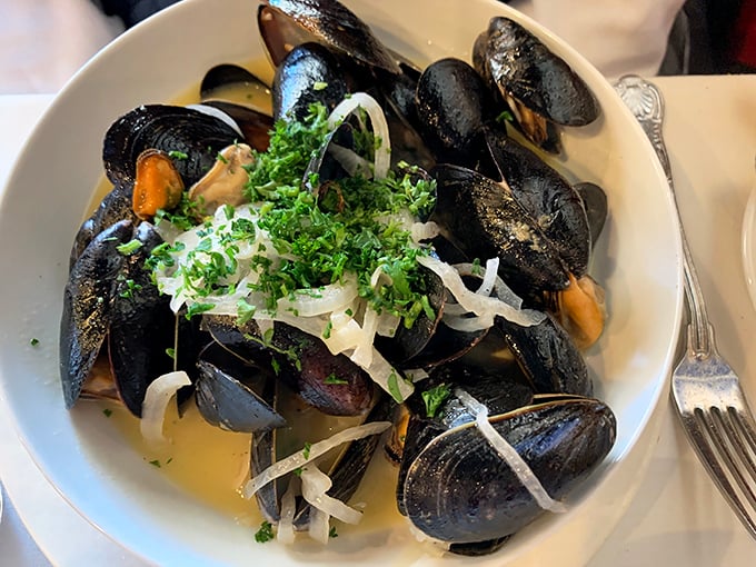 Plump mussels bathed in fragrant broth and topped with fresh herbs prove that sometimes the simplest preparations yield the most profound flavors.