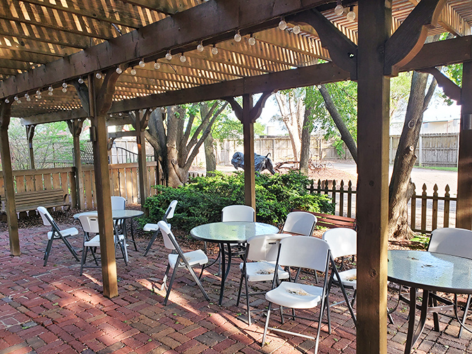 The outdoor patio offers a breath of fresh air between bites of decadence. Dappled sunlight filtering through the pergola creates the perfect ambiance.