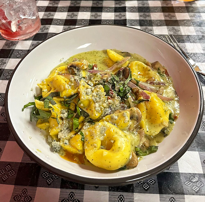 Tortellini bathing in a pool of pesto that's so vibrant it practically photosynthesizes under the restaurant lights.