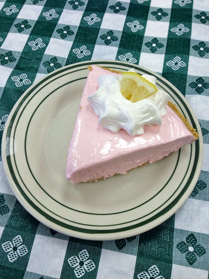 Pink lemonade pie with a dollop of whipped cream and lemon slice—summer captured in a dessert that's both nostalgic and refreshing.