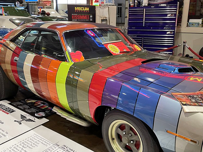 This rainbow-striped Plymouth proves that sometimes the most outrageous paint jobs create the most memorable automotive art pieces.