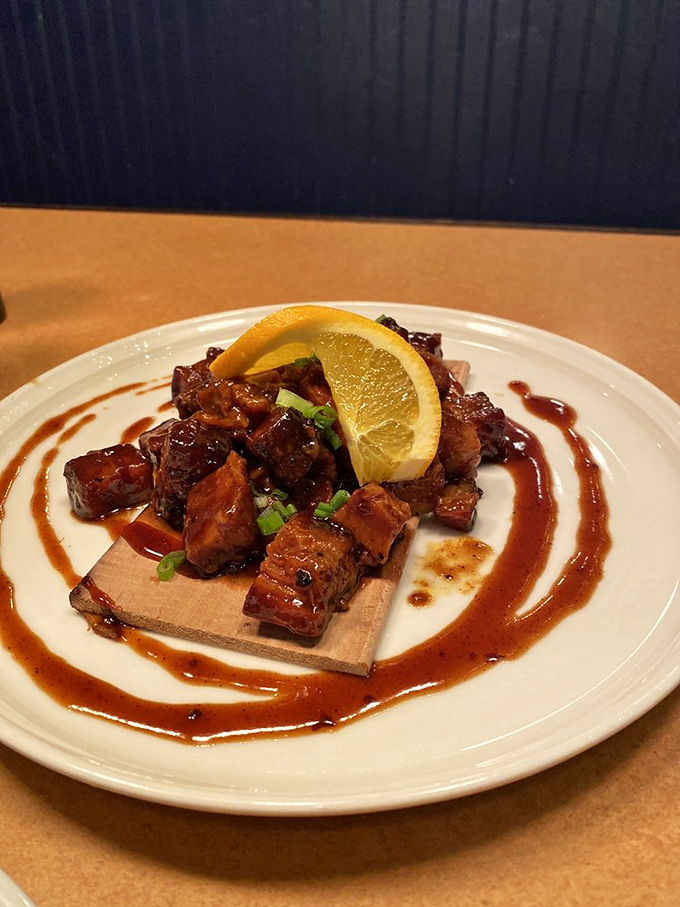Pork belly burnt ends: where smoke, sweet, and savory perform a perfect three-part harmony on a cedar plank stage. The lemon wedge conducts.