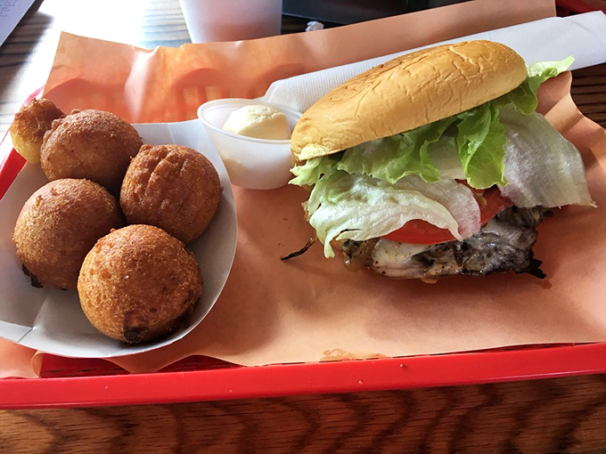 The sandwich that launches a thousand road trips. Those golden hush puppies are the unsung heroes of the barbecue world.