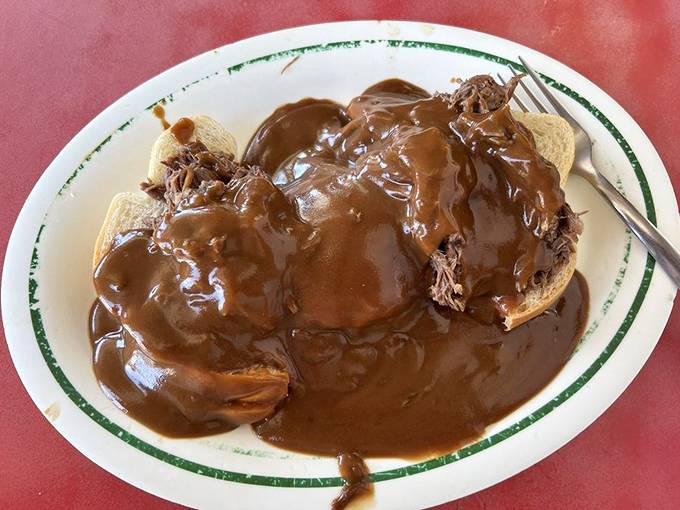 Open-faced roast beef swimming in gravy so rich it could apply for a loan. This isn't just comfort food&mdash;it's a warm hug on a plate.