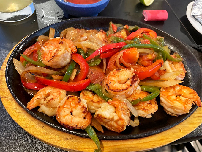 Shrimp fajitas sizzling with ambition—the peppers still have personality, the onions sweet surrender, and the shrimp maintaining their dignity throughout.